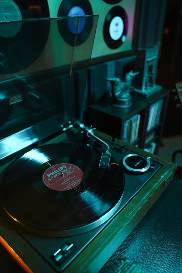 Vintage turntable playing a vinyl record in a retro studio