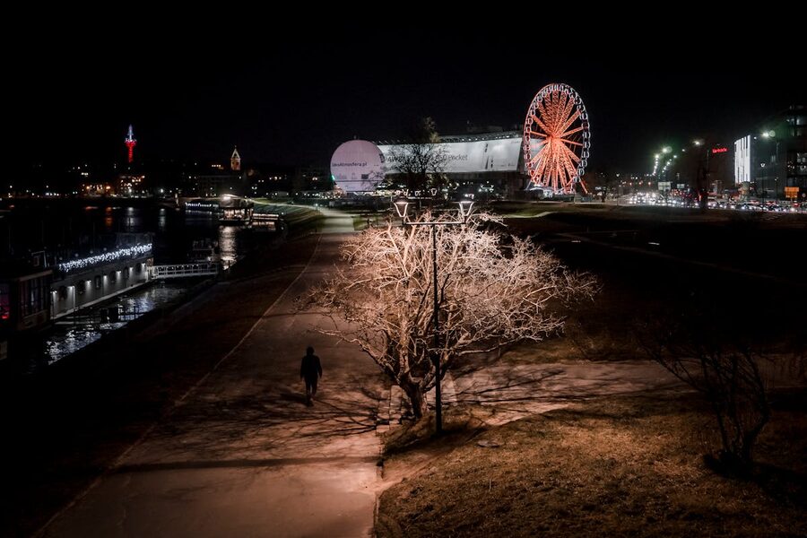 Vistula riverbank in Krakow with trees and buildings