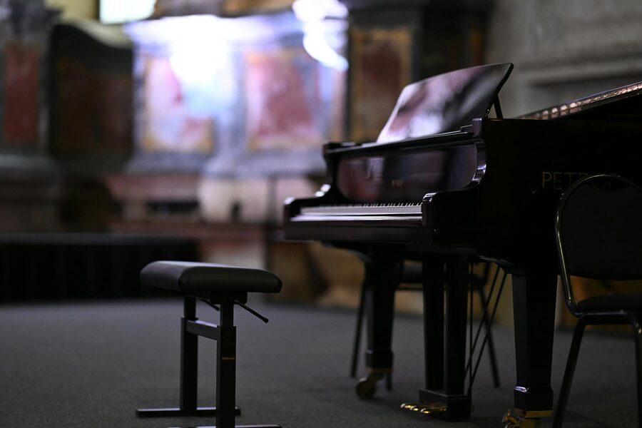 Grand piano in an ornate concert hall