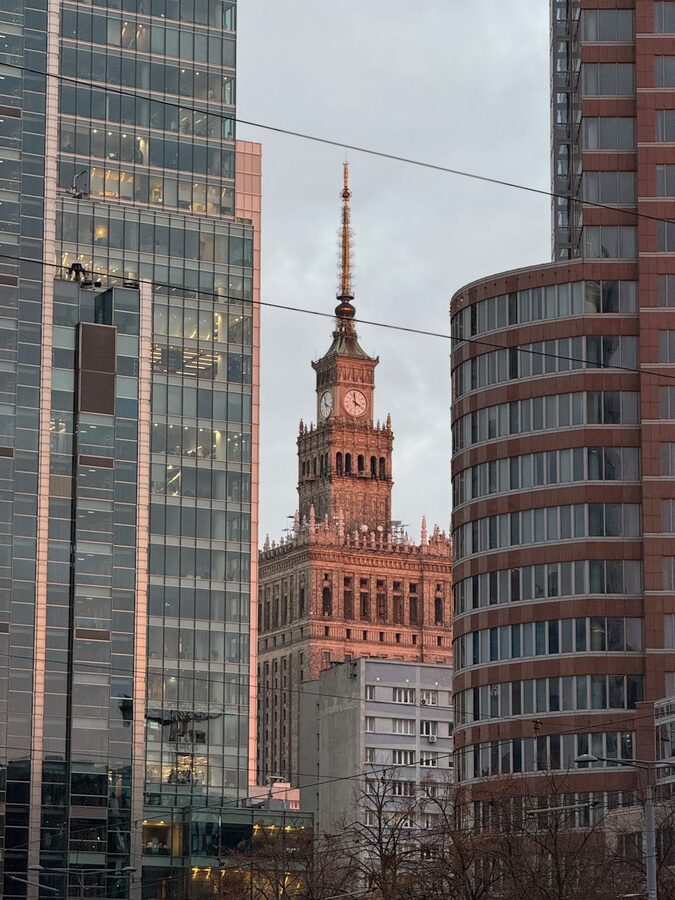 Palace of Culture seen between modern buildings in Warsaw