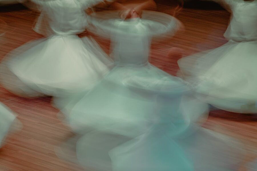 Long exposure photograph of whirling dervishes spinning