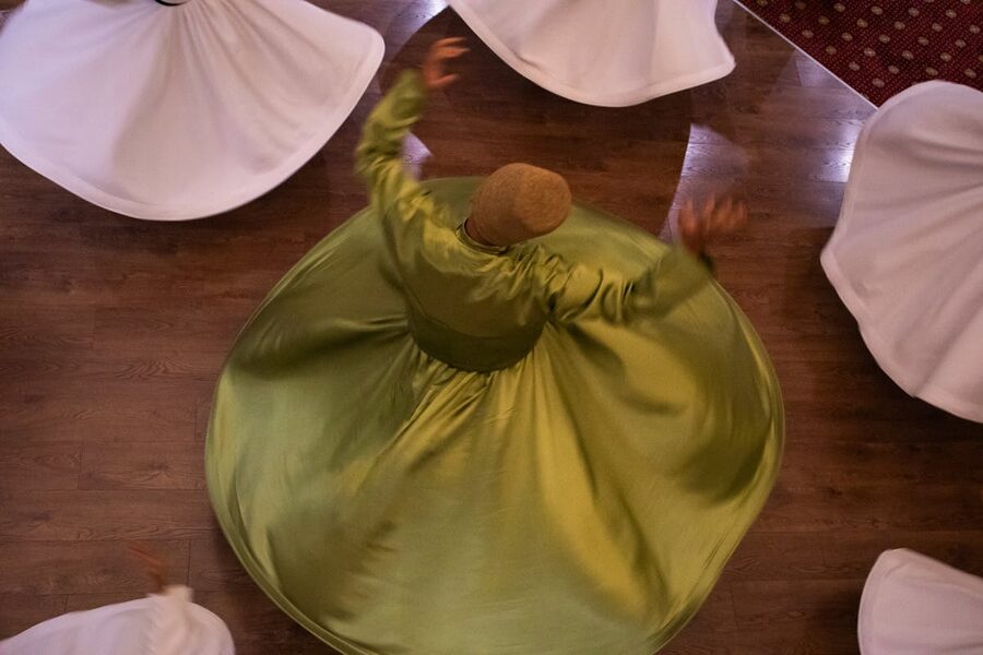 Overhead view of whirling dervishes spinning in white robes
