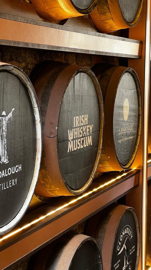 Barrels at the Irish Whiskey Museum in Dublin with whiskey brand labels