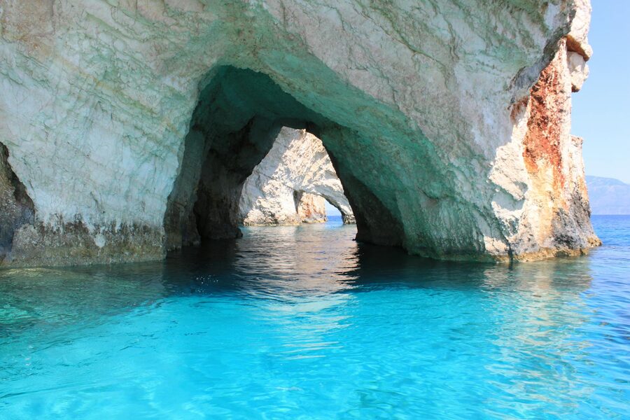 Blue caves in Zakynthos, Greece, with a small boat
