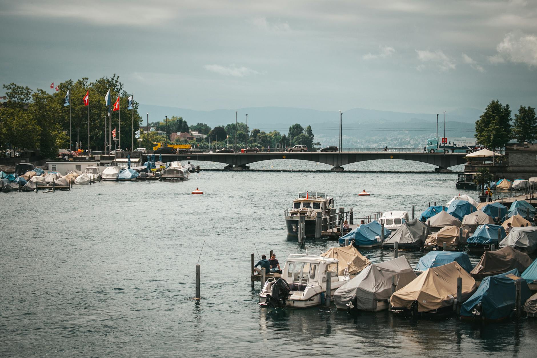 Boats anchored near a bridge over the Limmat River in Zurich