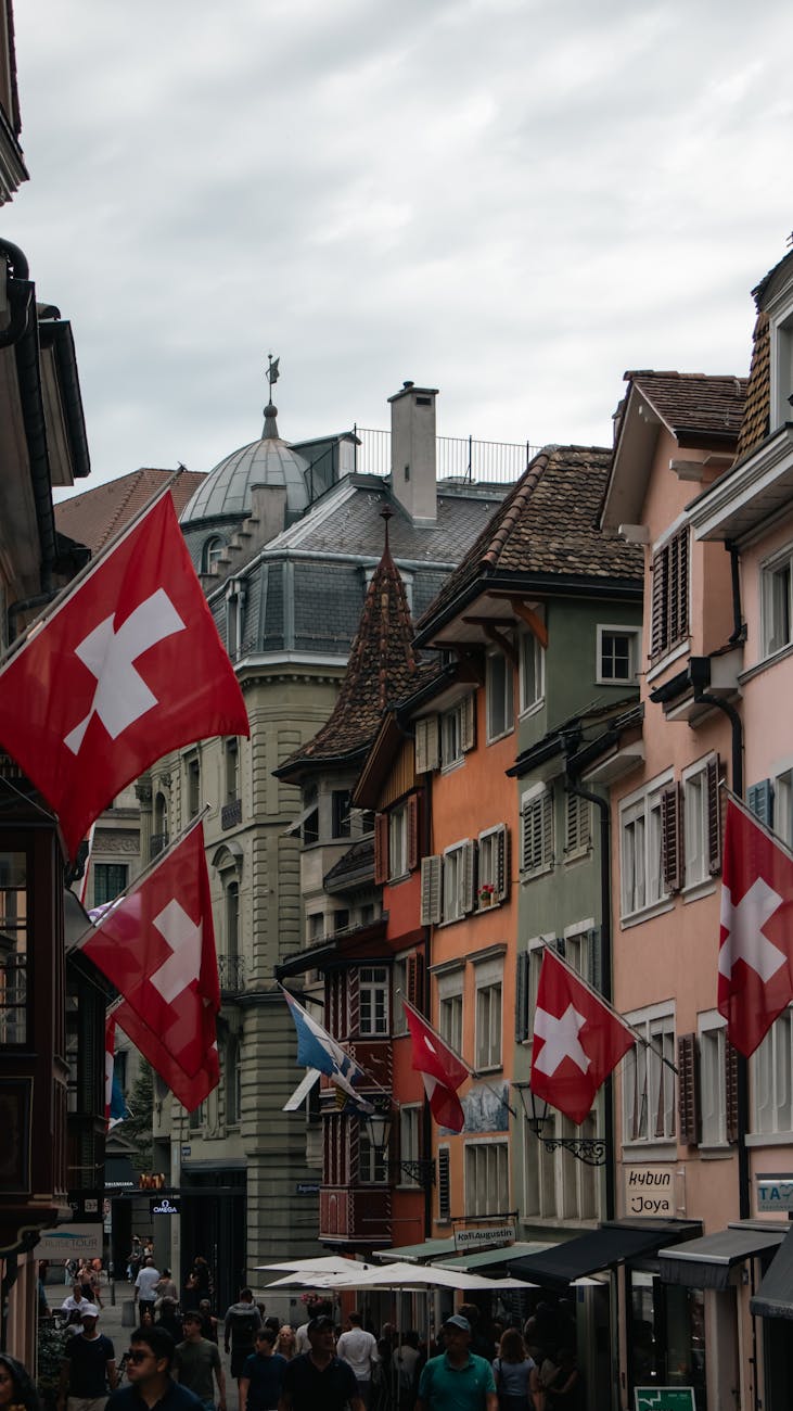 Zurich street with Swiss flags and colourful buildings