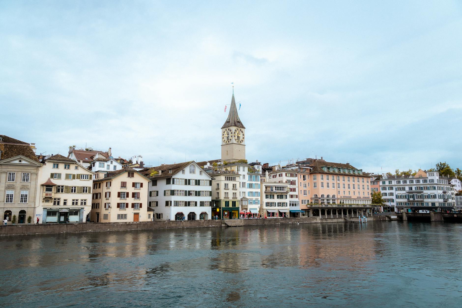 Zurich lakefront with historic clock tower at sunset