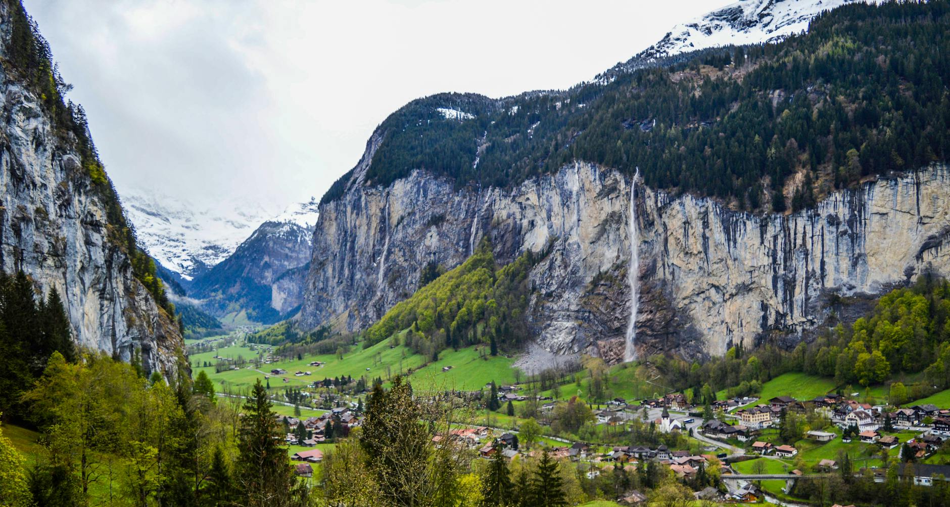 Lauterbrunnen village in a deep valley with waterfalls and green terraces