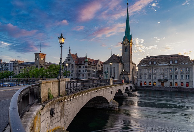 Zurich Limmat river bridge at twilight with Fraumünster church