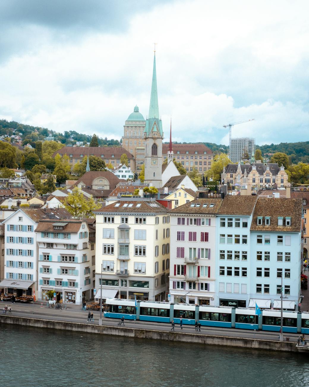 Blue tram in Zurich with historic buildings